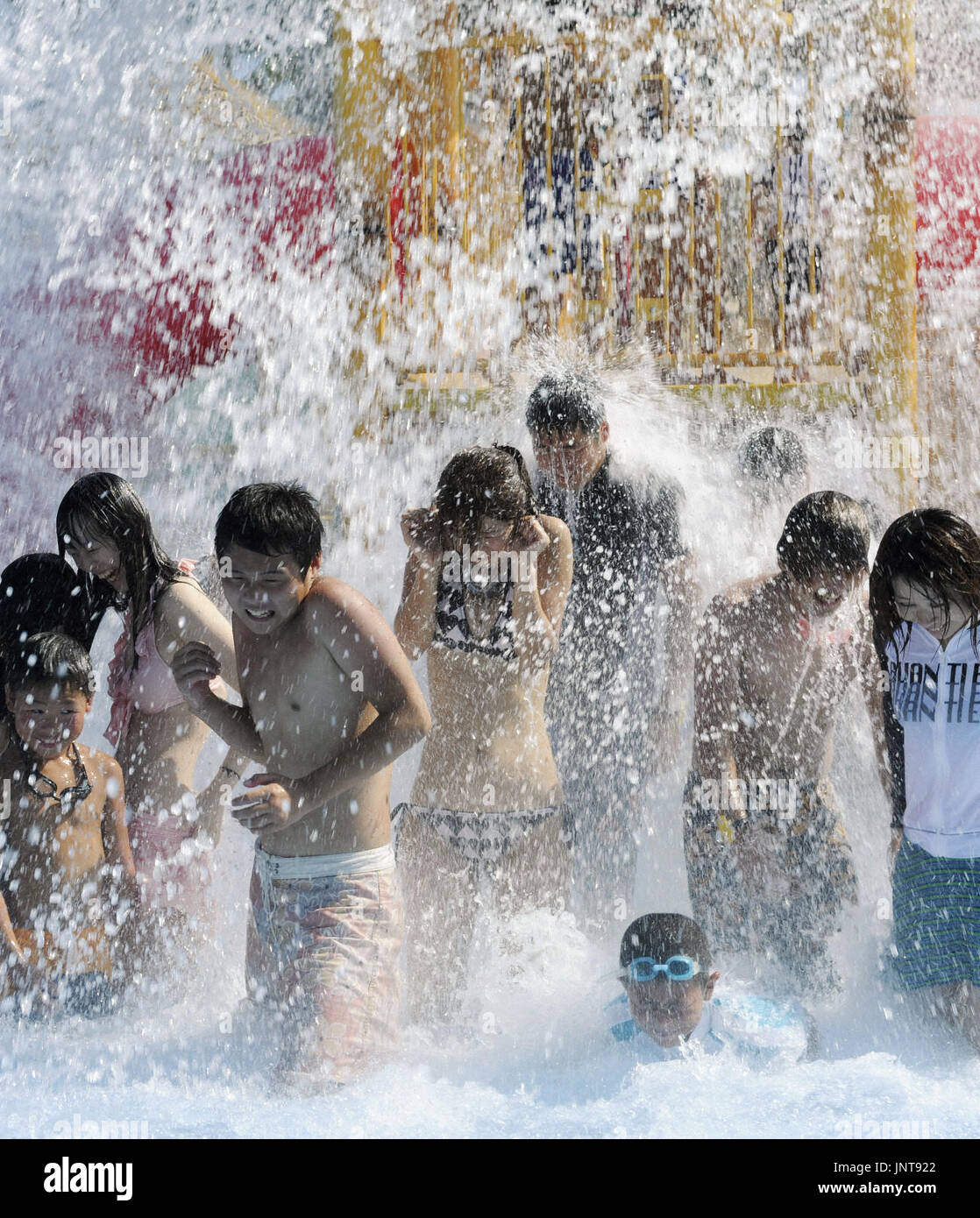 KUWANA, Japan - People cool themselves in water at Nagashima Spaland ...