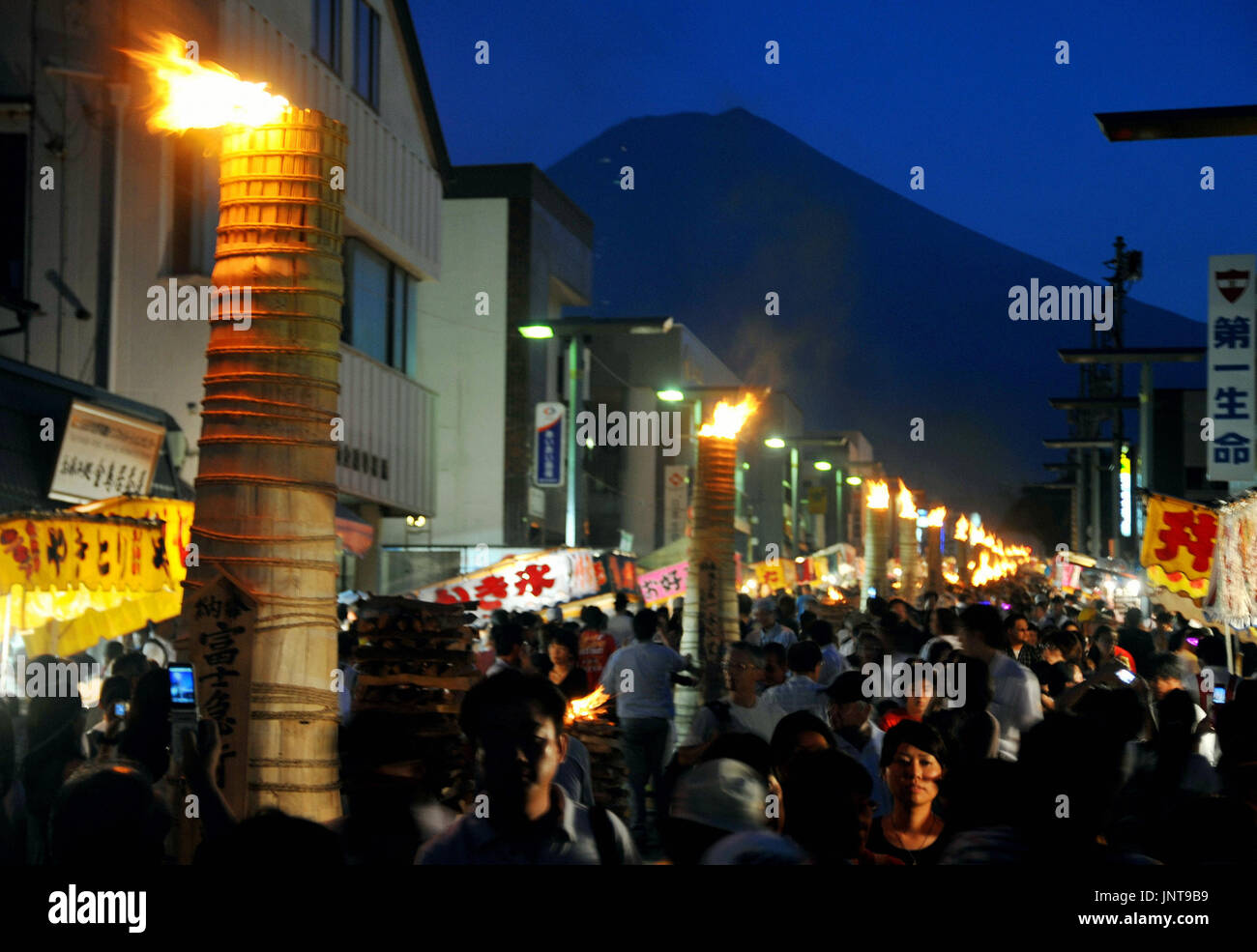 FUJIYOSHIDA, Japan - About 3-meter-tall torches are lit along a ...