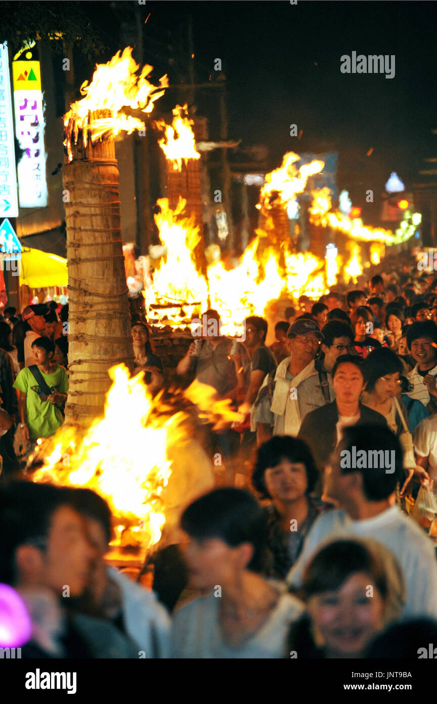FUJIYOSHIDA, Japan - About 3-meter-tall torches are lit along a ...