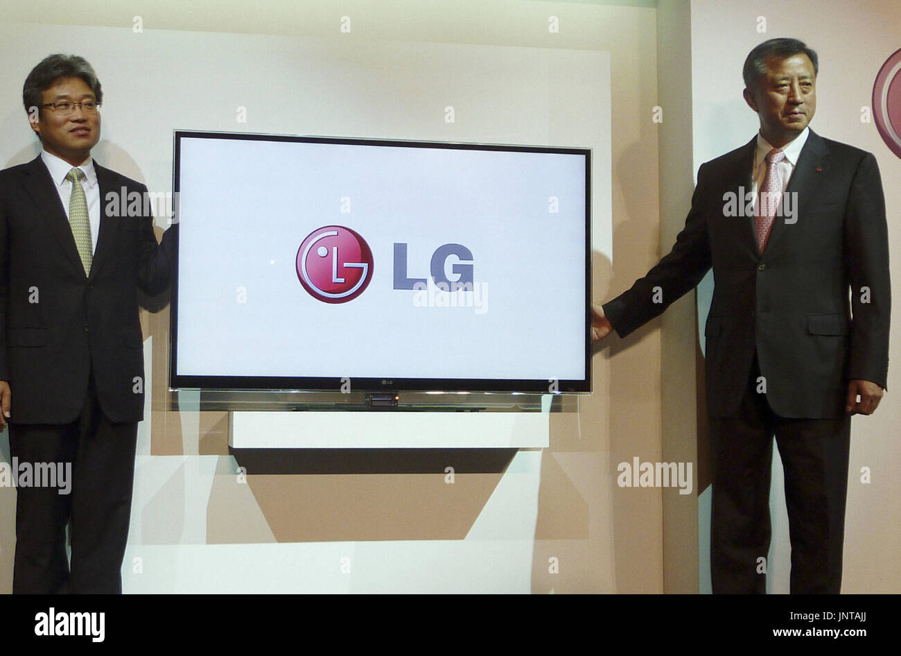 TOKYO, Japan - Two presenters demonstrate a liquid crystal display ...
