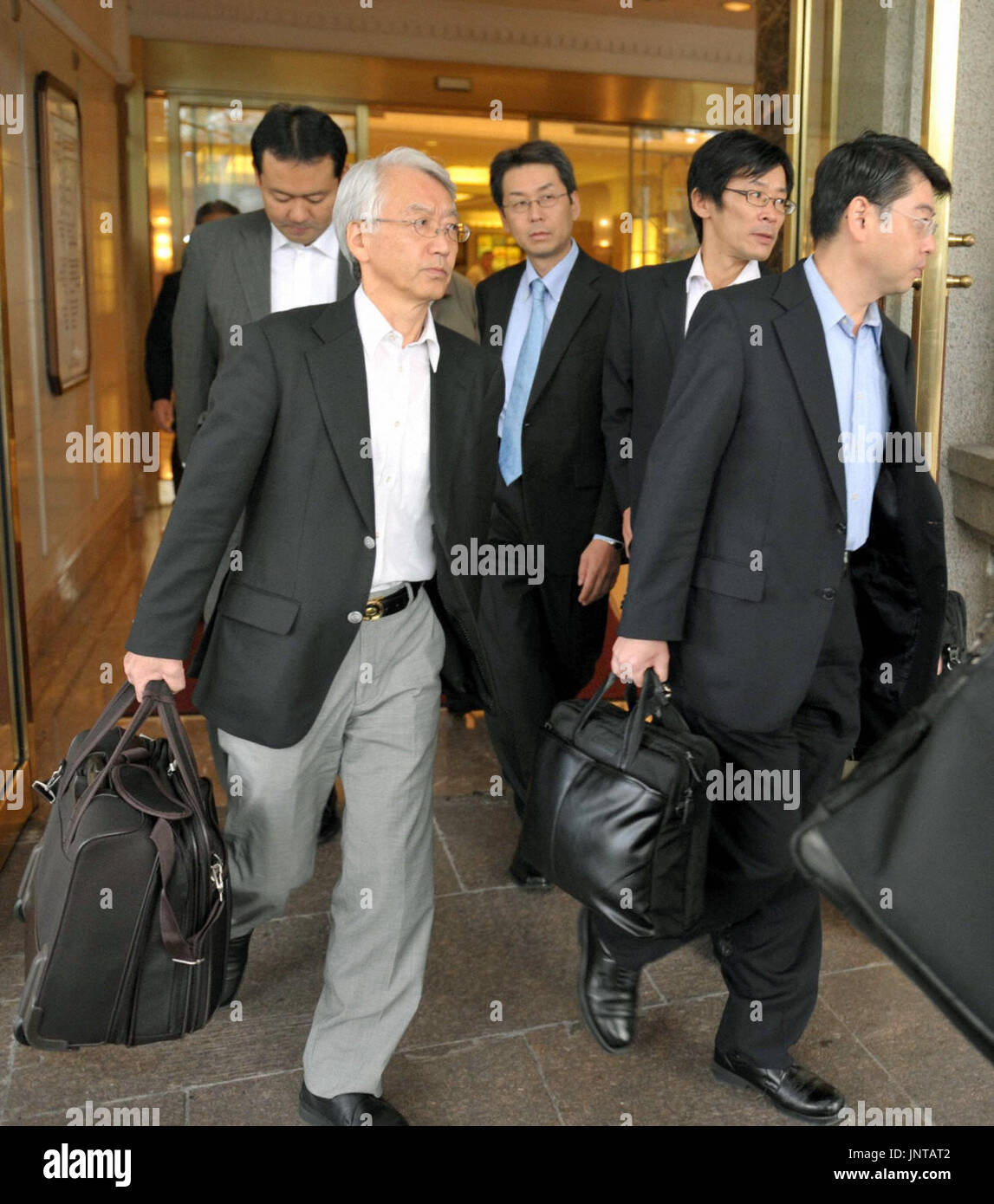 SHANGHAI, China - Fujita Corp. employees Yoshiro Sasaki (R, front), Junichi Iguchi (L, front ...