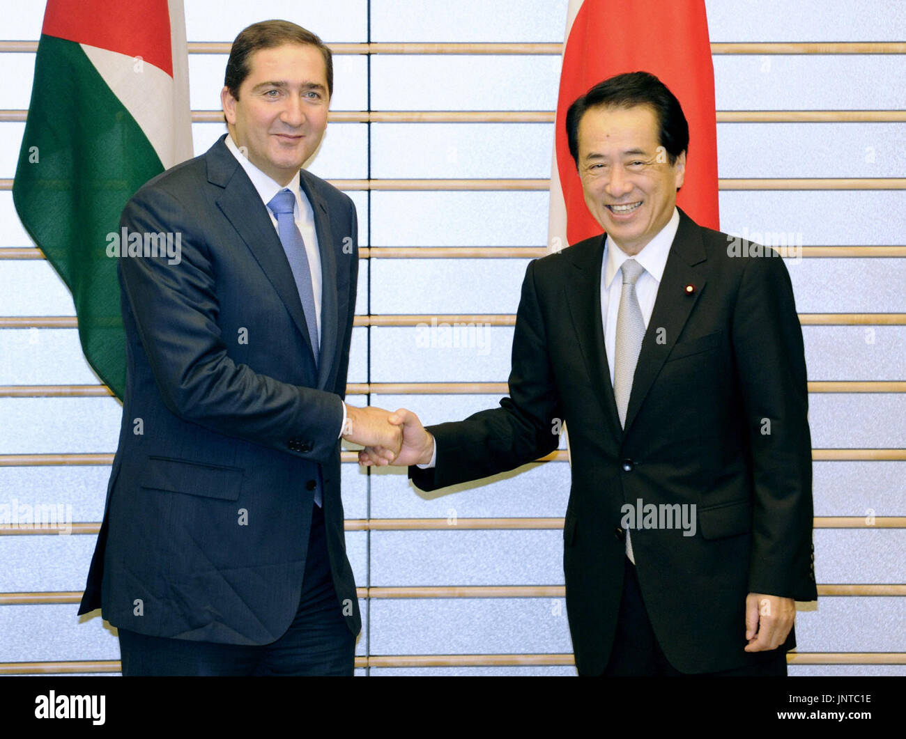 TOKYO, Japan - Japanese Prime Minister Naoto Kan (R) shakes hands with ...