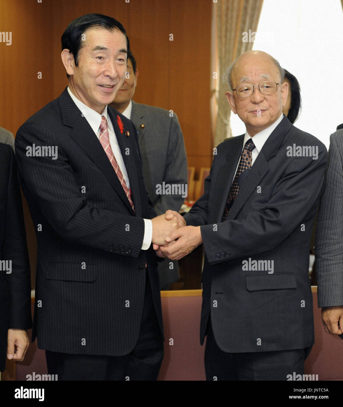 TOKYO, Japan - Nobel Prize-winning chemist Akira Suzuki (R) shakes ...