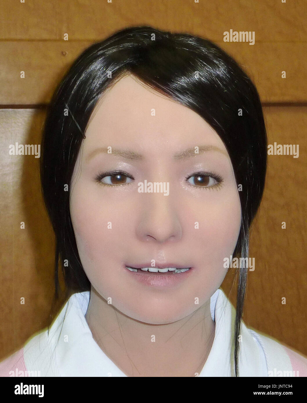 TOKYO, Japan - A woman-like robot smiles during a demonstration in ...