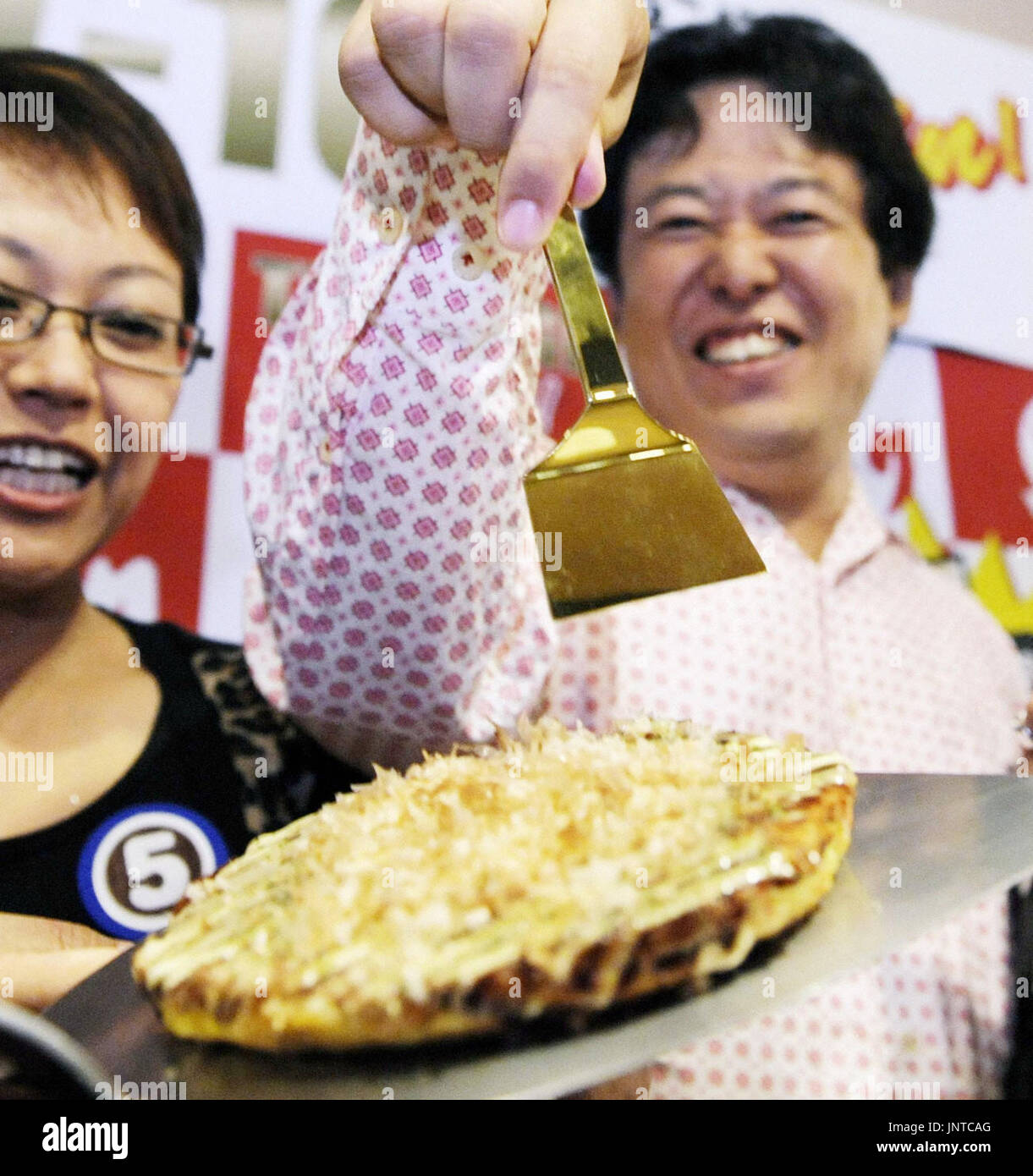 OSAKA, Japan - Photo shows an ''okonomiyaki'' Japanese-style savory ...