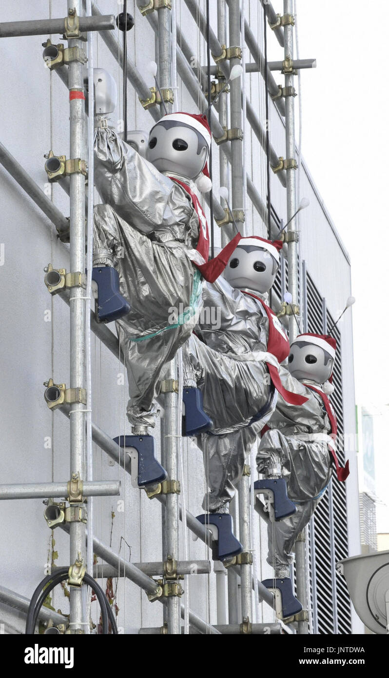 OSAKA, Japan - Three Dream Robo humanoids dressed in Santa Claus ...