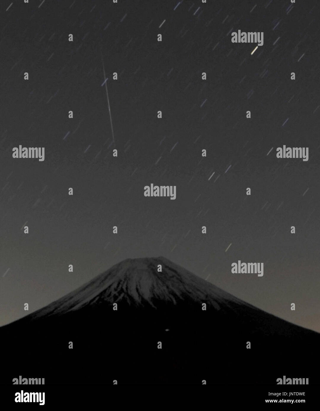 FUJINOMIYA, Japan - The Geminid meteor shower is observed over Mt. Fuji ...