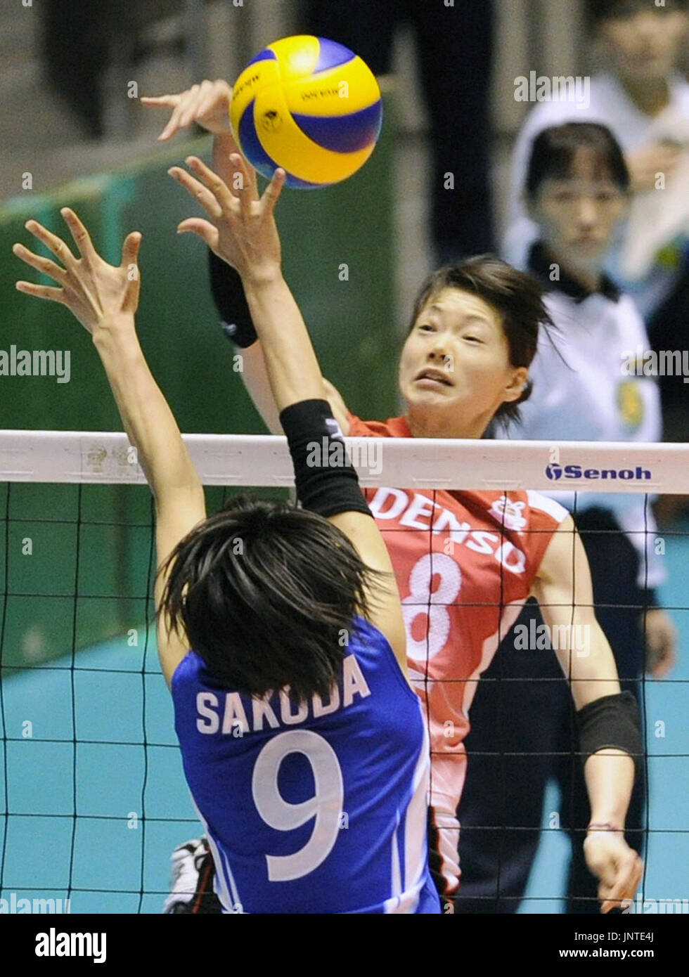 TOKYO, Japan - Kaori Inoue of the Denso Airybees (back) spikes the ball ...