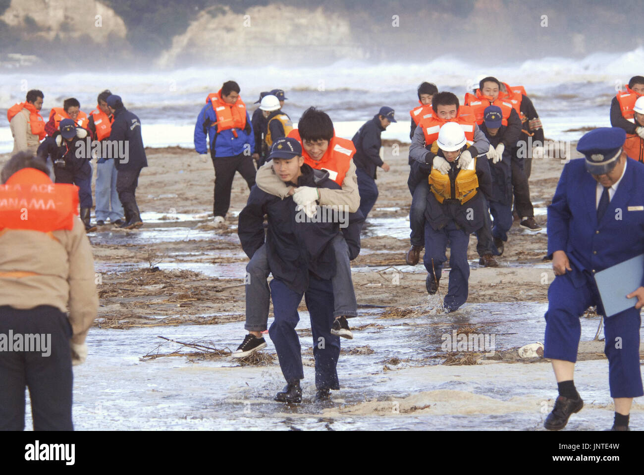 IWAKI, Japan - Japan Coast Guard personnel rescue crew members of the ...