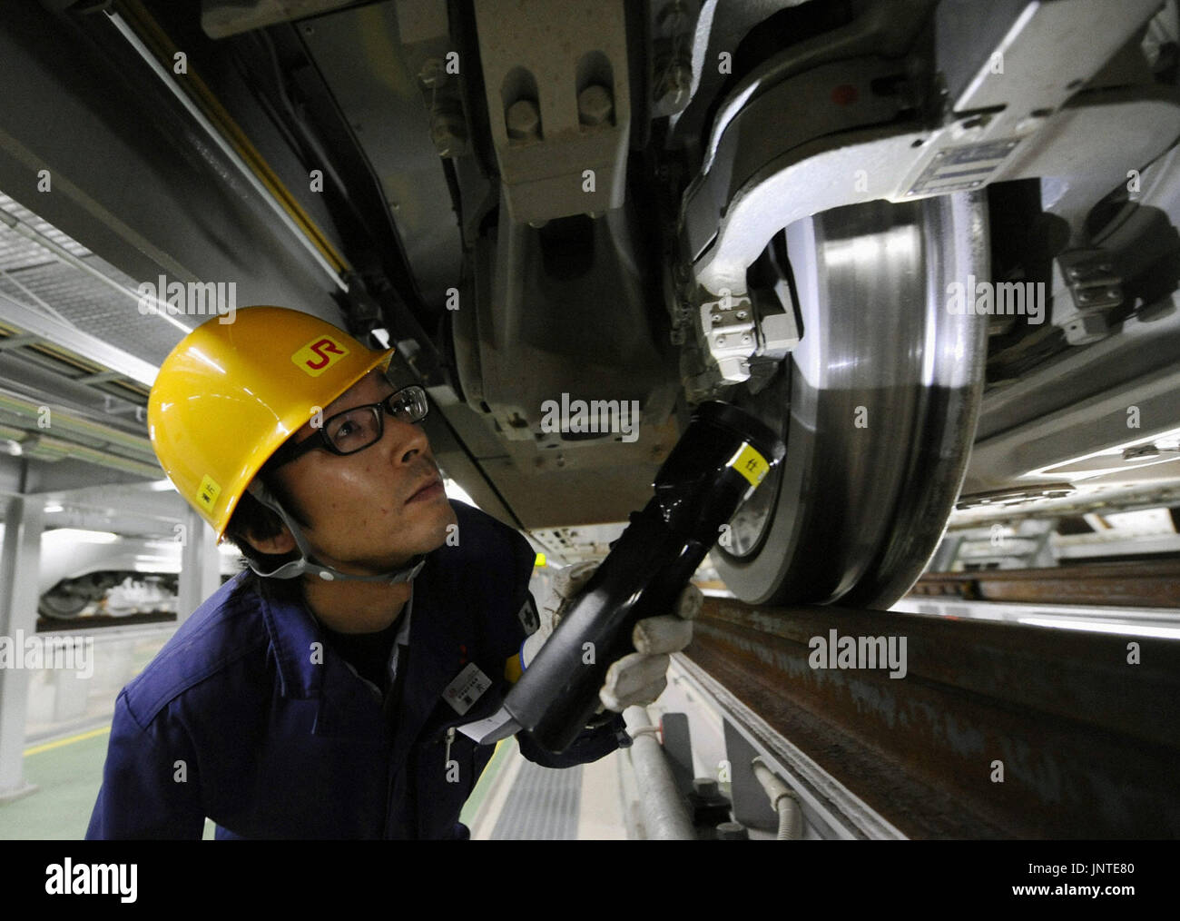 FUKUOKA, Japan - A worker inspects a Kyushu Shinkansen Line bullet ...