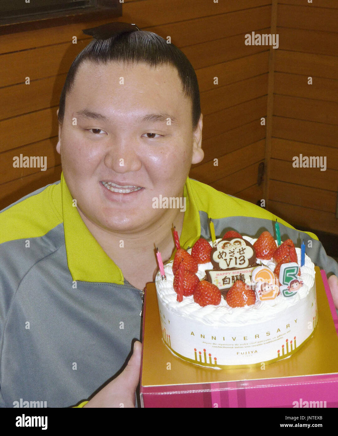 OSAKA, Japan - Sumo grand champion Hakuho holds a cake to celebrate his ...
