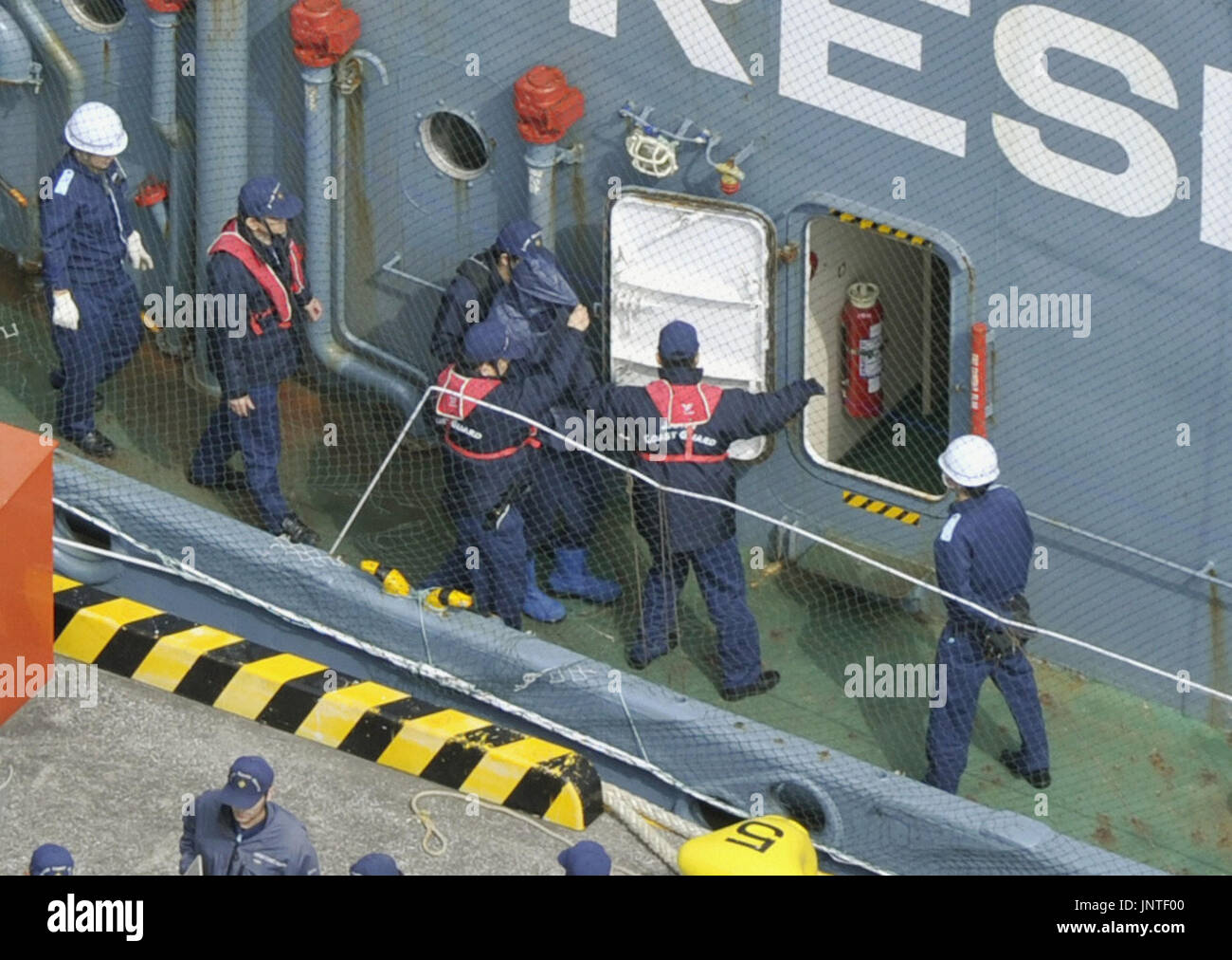 YOKOHAMA, Japan - Peter Bethune (wearing hood) boards the whaling fleet ...