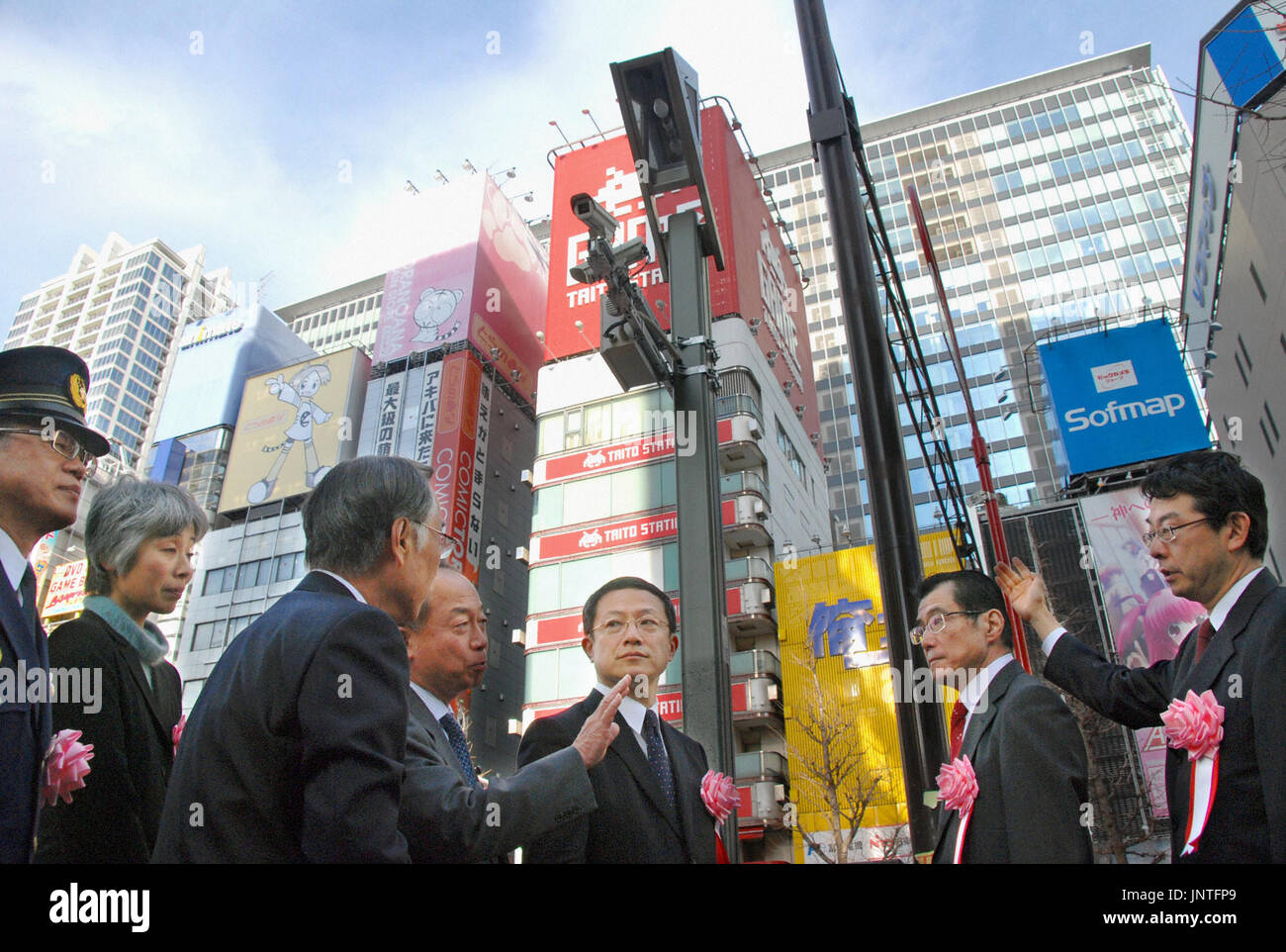 TOKYO, Japan - People talk under a security camera in Tokyo's Akihabara ...