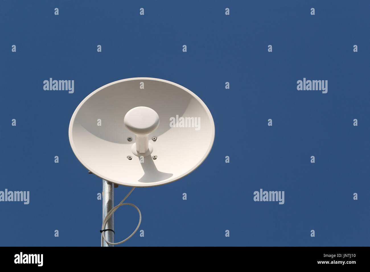 Wireless dish antenna and blue sky with copy space Stock Photo - Alamy
