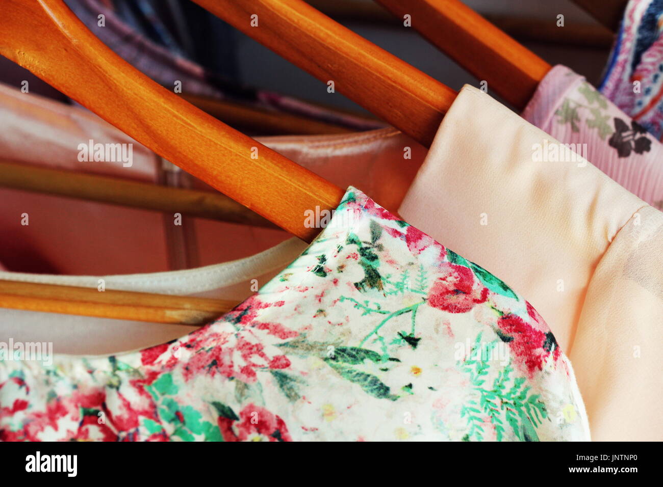 collection of women's clothes hanging on rack Stock Photo - Alamy