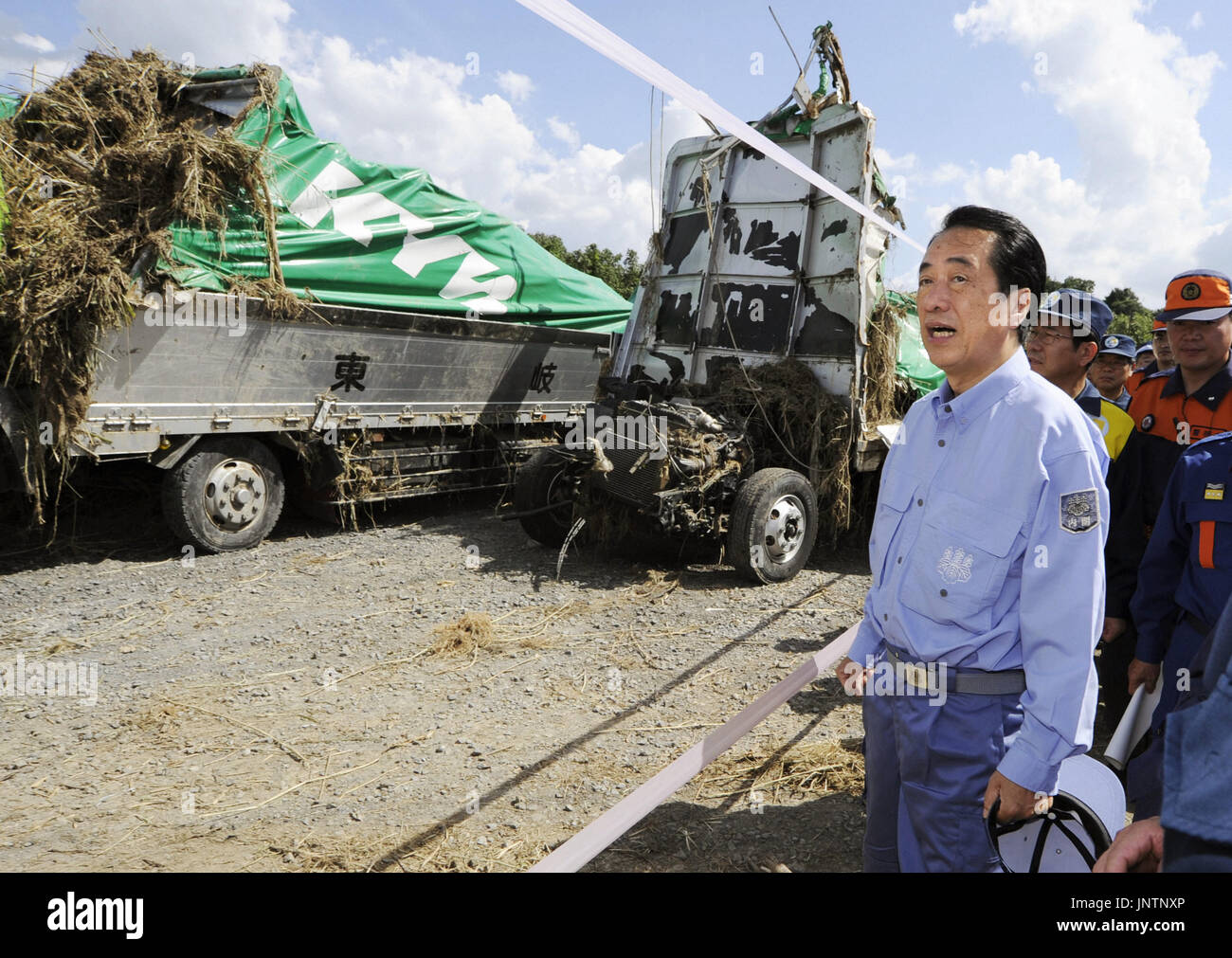 GIFU, Japan - Prime Minister Naoto Kan looks at trucks carried away by ...