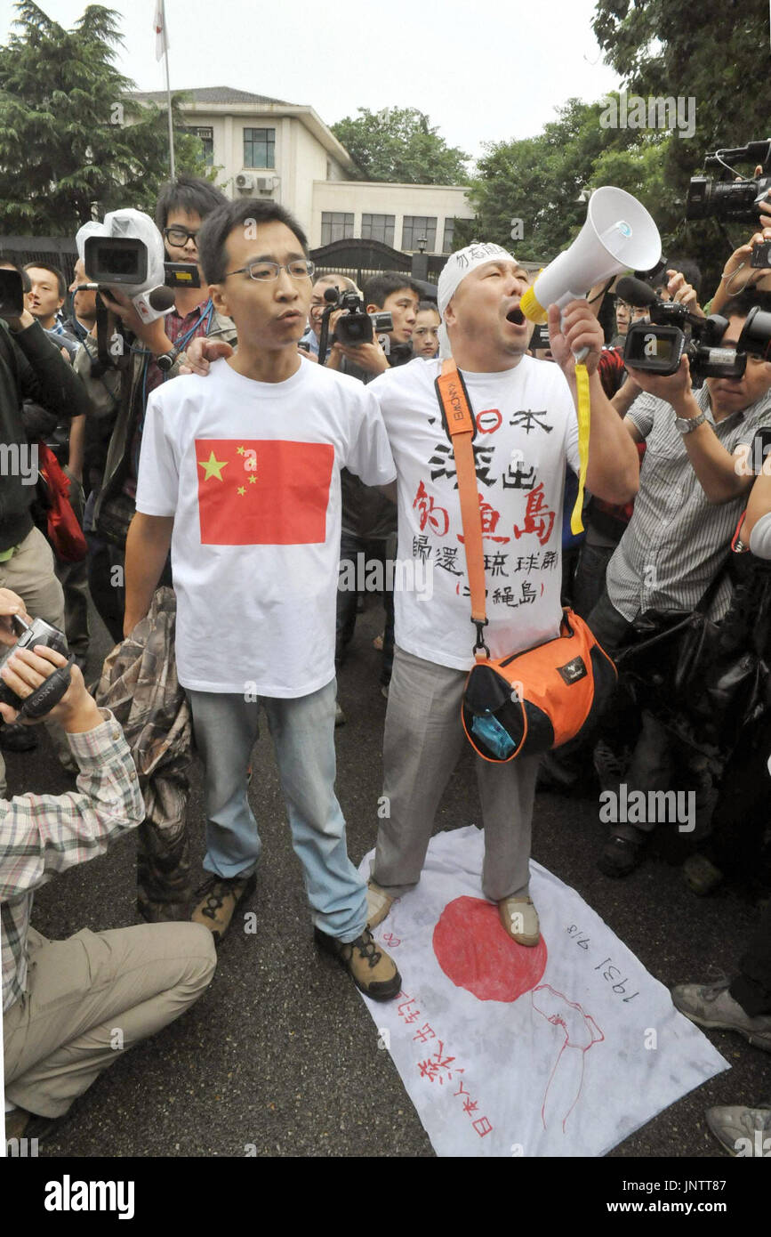 BEIJING, China - Reporters surround Chinese activists stepping on a ...