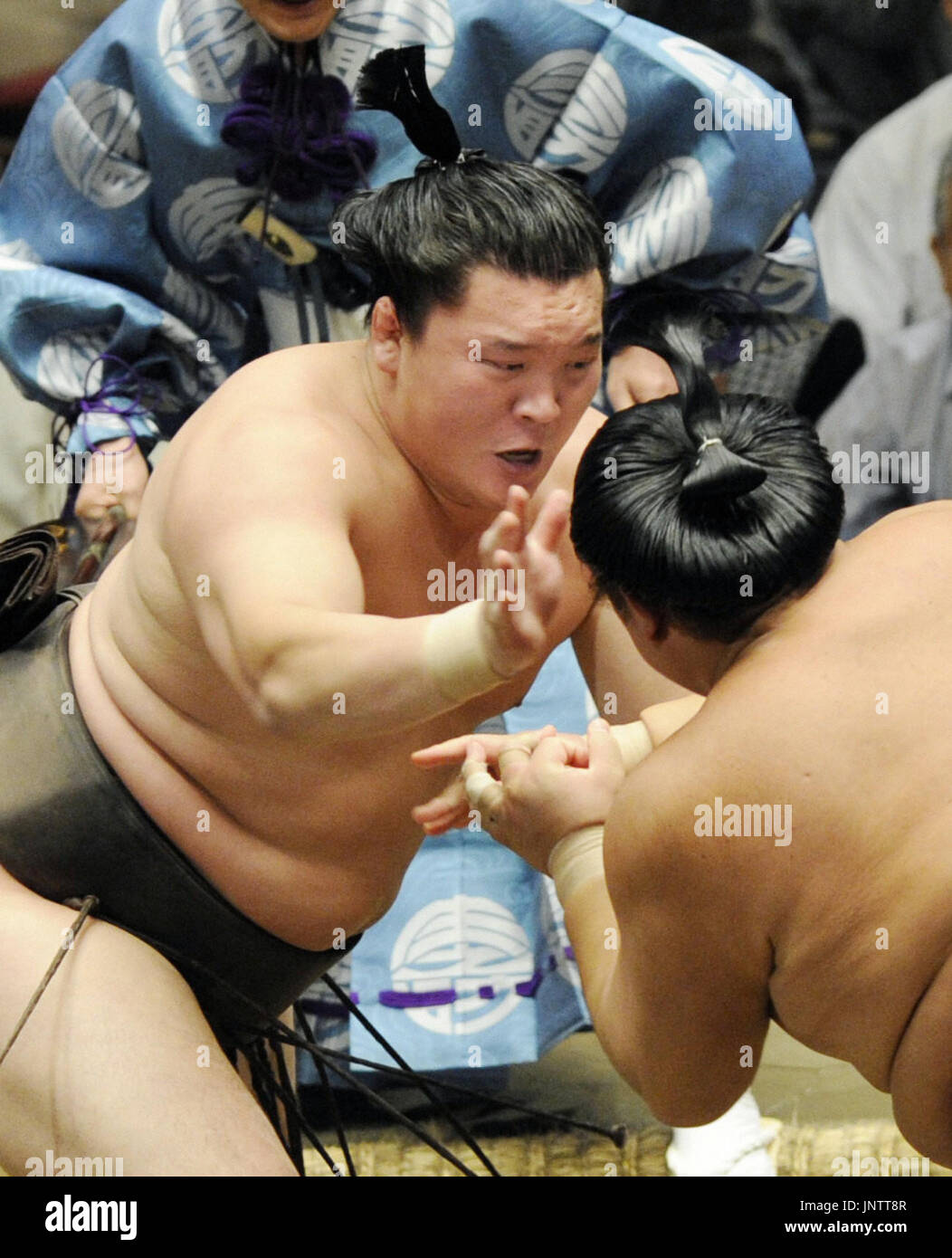 TOKYO, Japan - Mongolian grand champion Hakuho (L) pushes komusubi ...