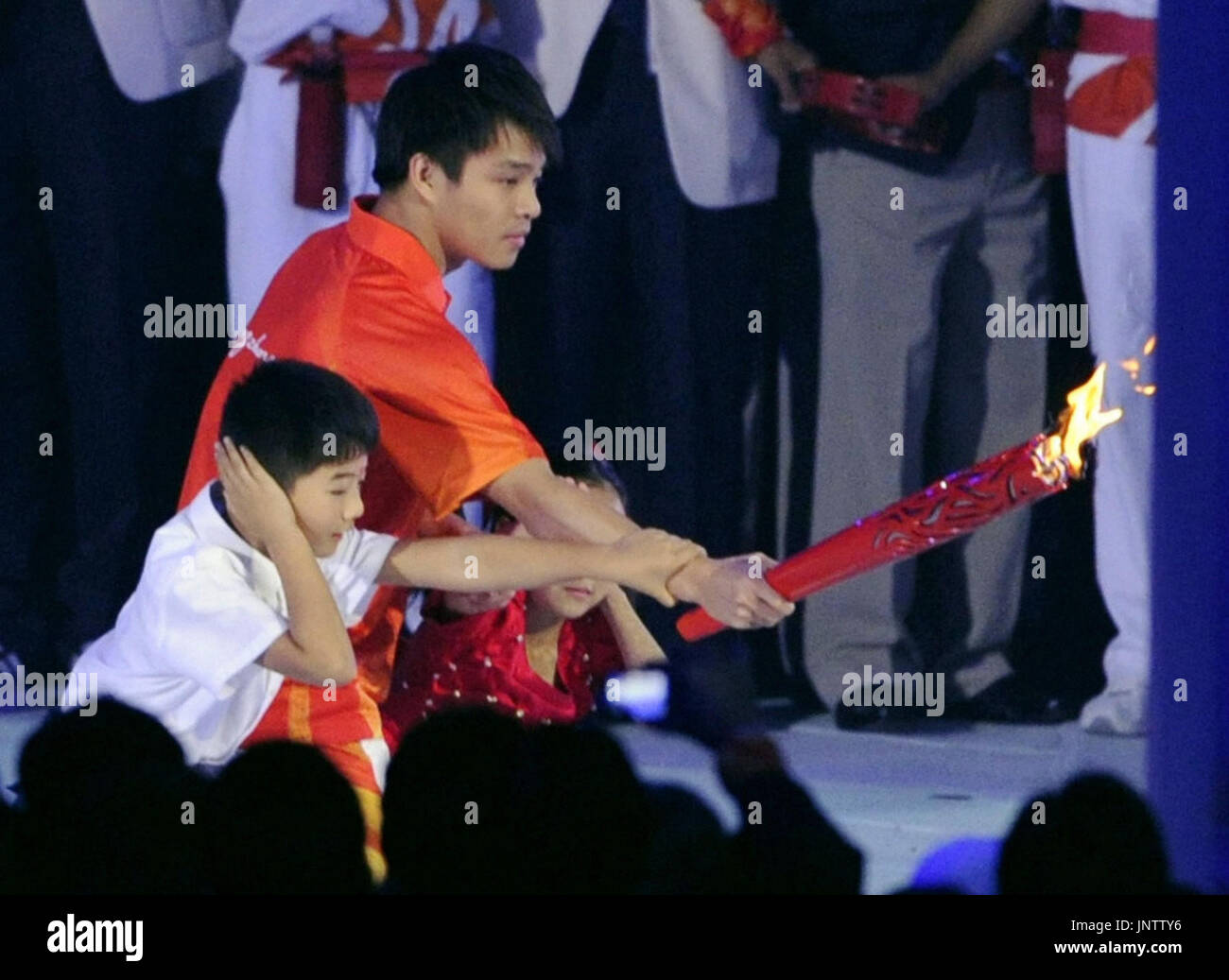 GUANGZHOU, China - Chinese diver He Chong lights the Asian Games' flame ...