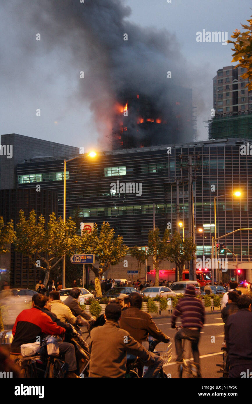 SHANGHAI, China - People watch a tower housing apartments for teachers ...