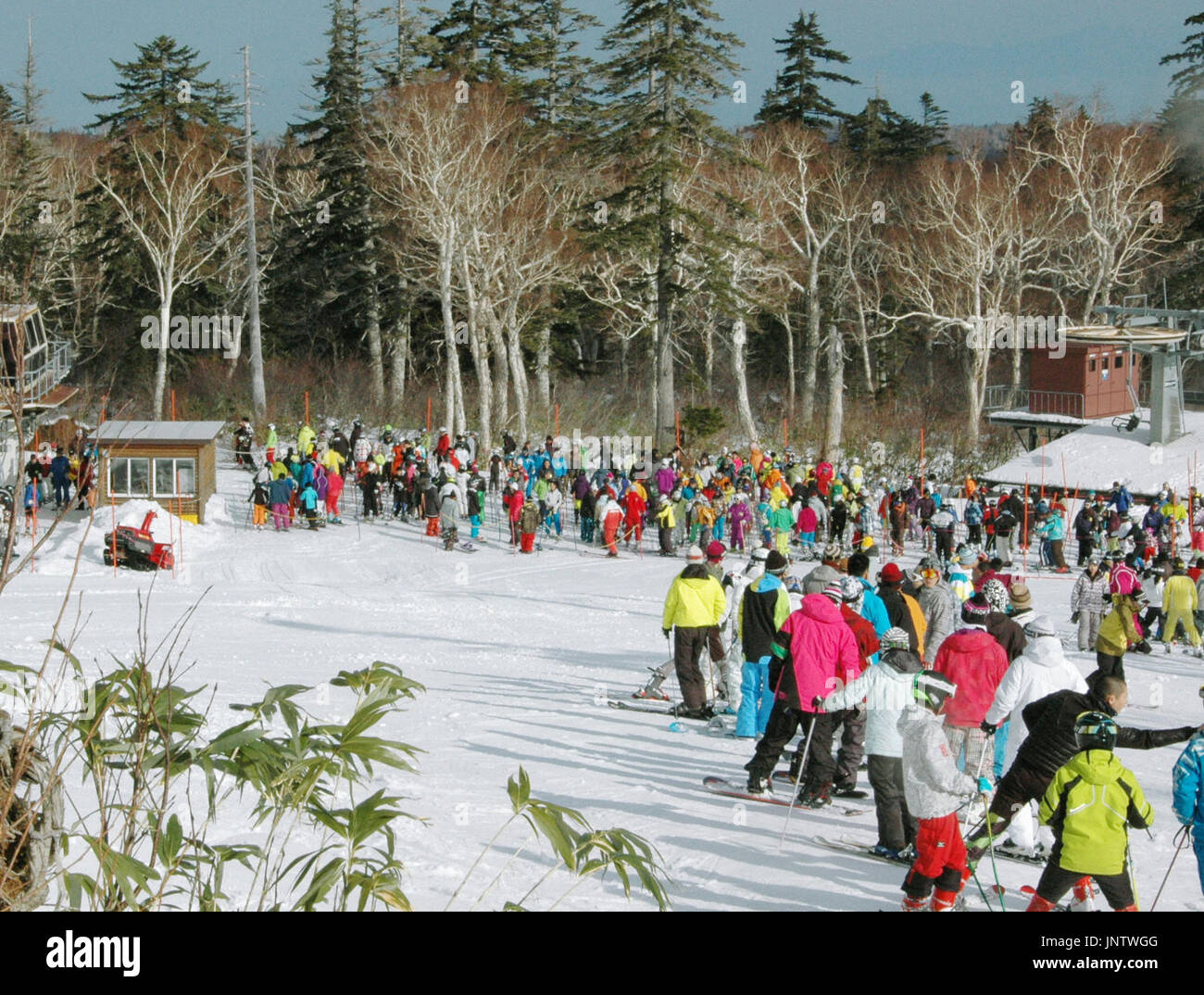 SAPPORO, Japan - Skiers and snowboarders line up to take lifts at the ...