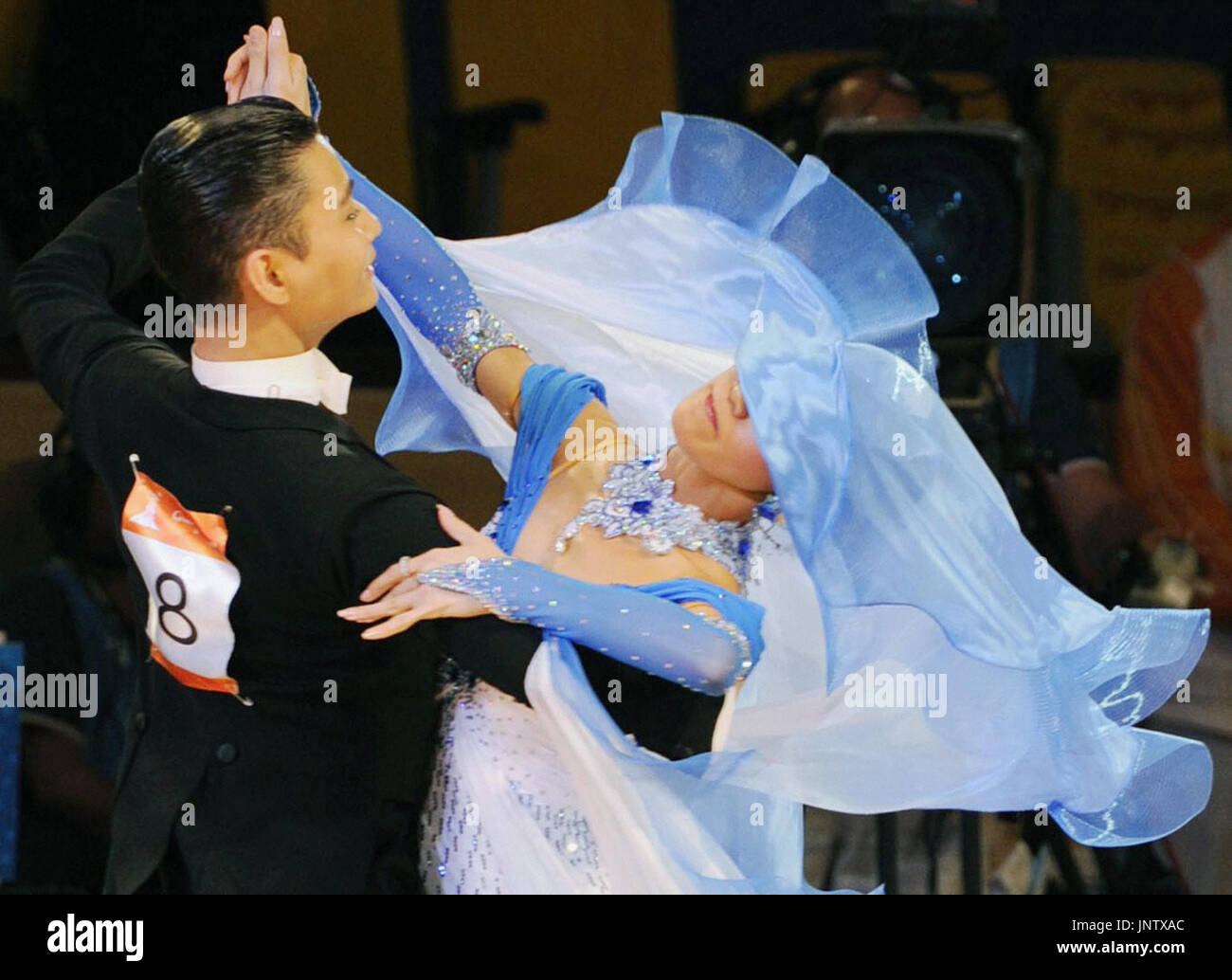 GUANGZHOU, China - A dancer's face is covered by her dress while ...