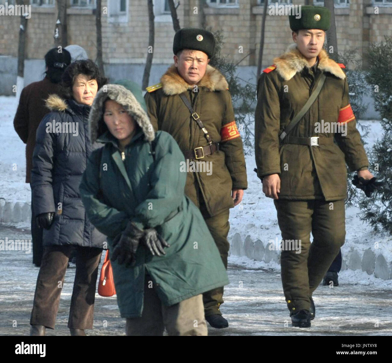 PYONGYANG, North Korea - Citizens and soldiers walk on a street in ...