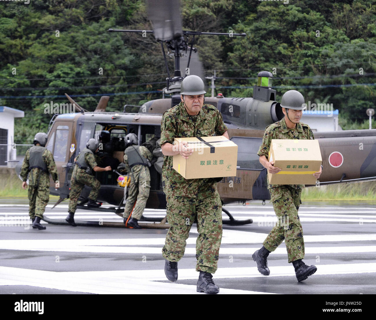 AMAMI, Japan - Members of the Ground Self-Defense Force carry relief ...