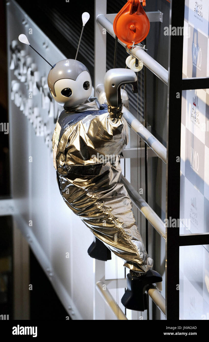 OSAKA, Japan - A robot climbs a ladder during a demonstration in Osaka ...