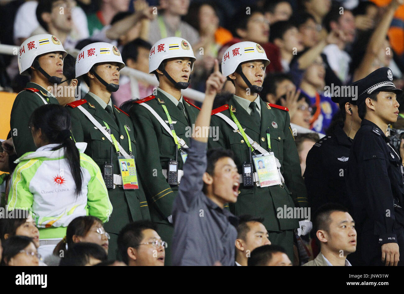 GUANGZHOU, China - Security guards watch Japan take the lead against ...