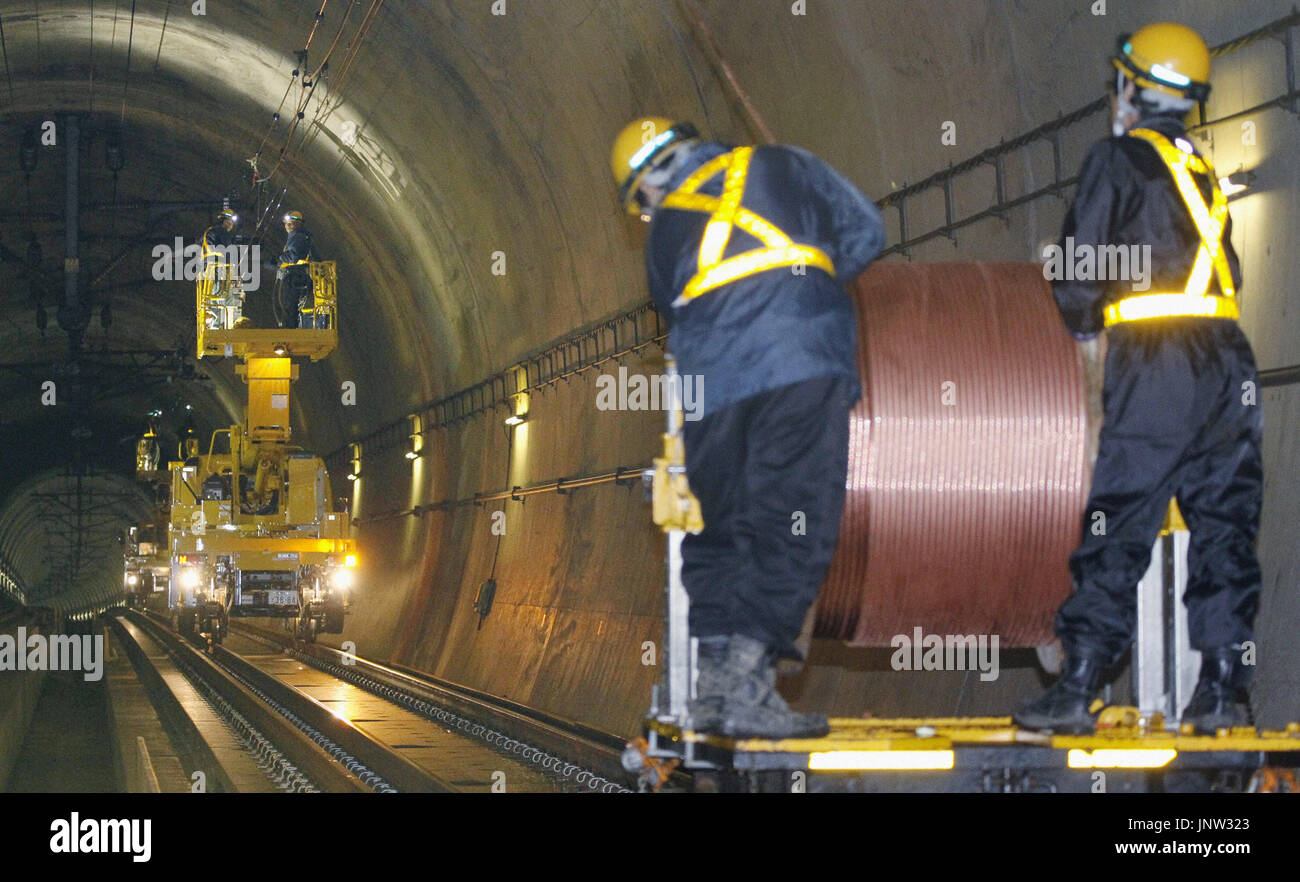 HAKODATE, Japan - Workers renew power supply lines in the Omonai Tunnel in Shiriuchi, Hokkaido ...