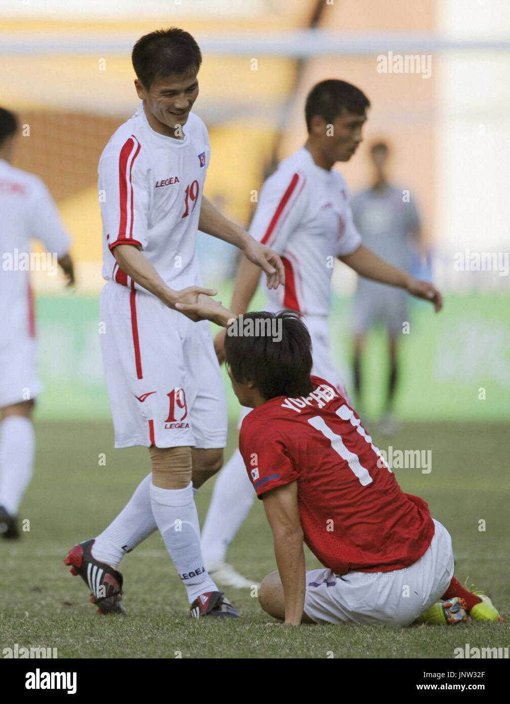 GUANGZHOU, China - North Korea striker An Chol Hyok helps South Korea ...