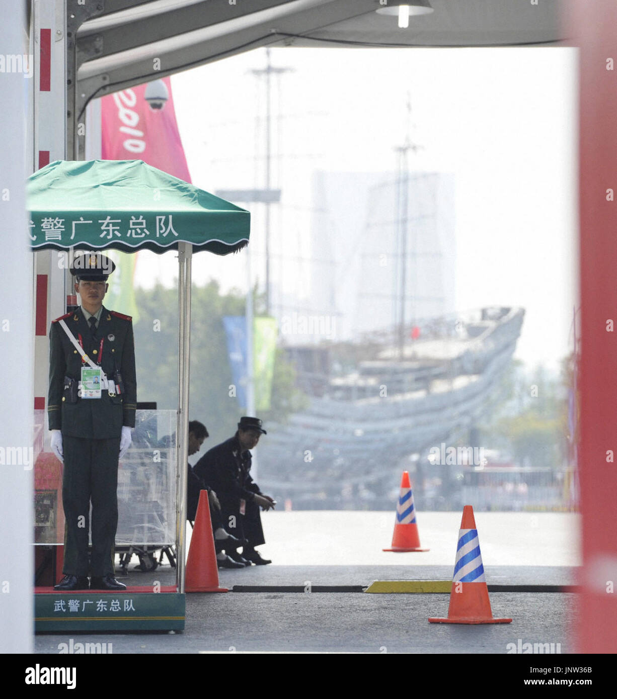 GUANGZHOU, China - An armed police officer guards an entrance of the ...