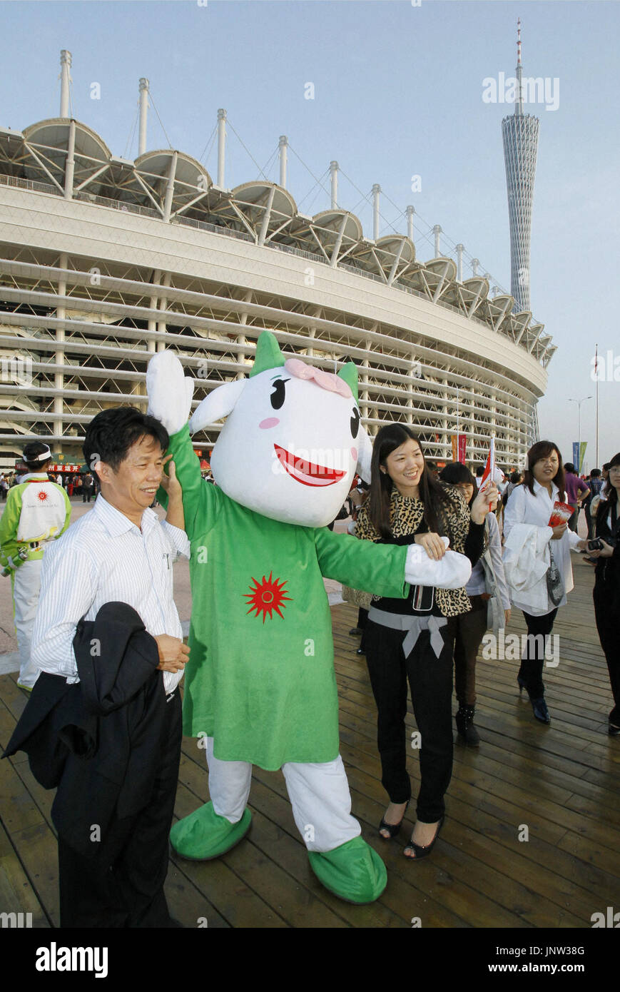 GUANGZHOU, China - An Asian Games mascot joins visitors in a photo ...