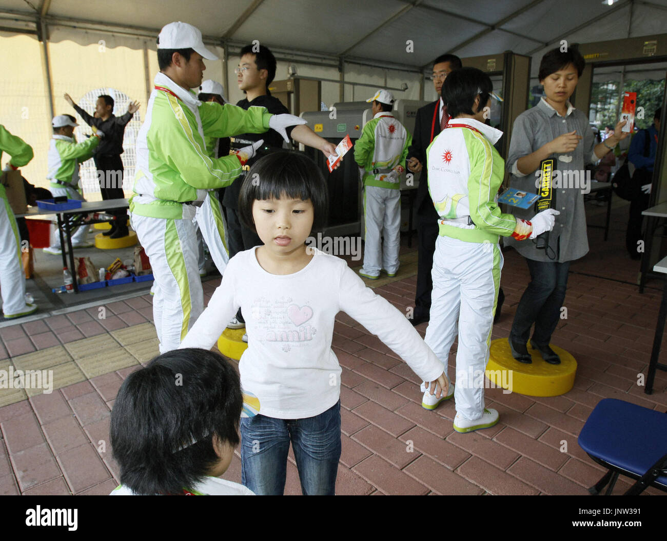 GUANGZHOU, China - People go through a security check before entering ...