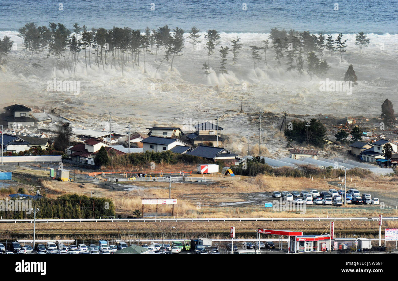 TOKYO, Japan - A massive tsunami engulfs a residential area after a ...