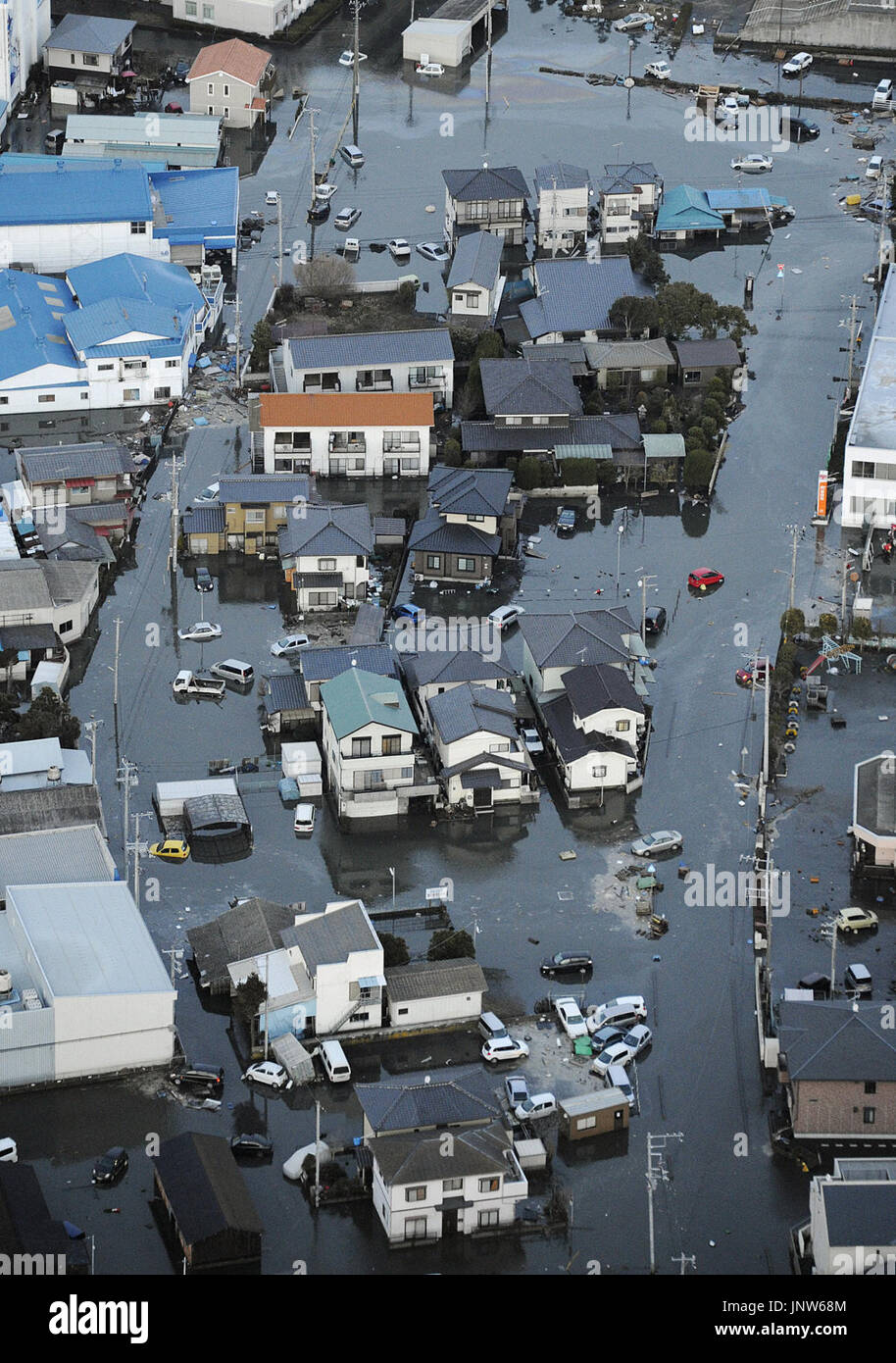 TOKYO, Japan - Houses and cars are submerged after a tsunami following ...