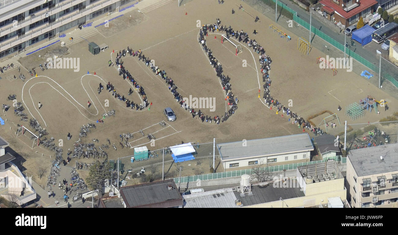 NIIGATA, Japan - A long line of people seeking water is formed at a ...