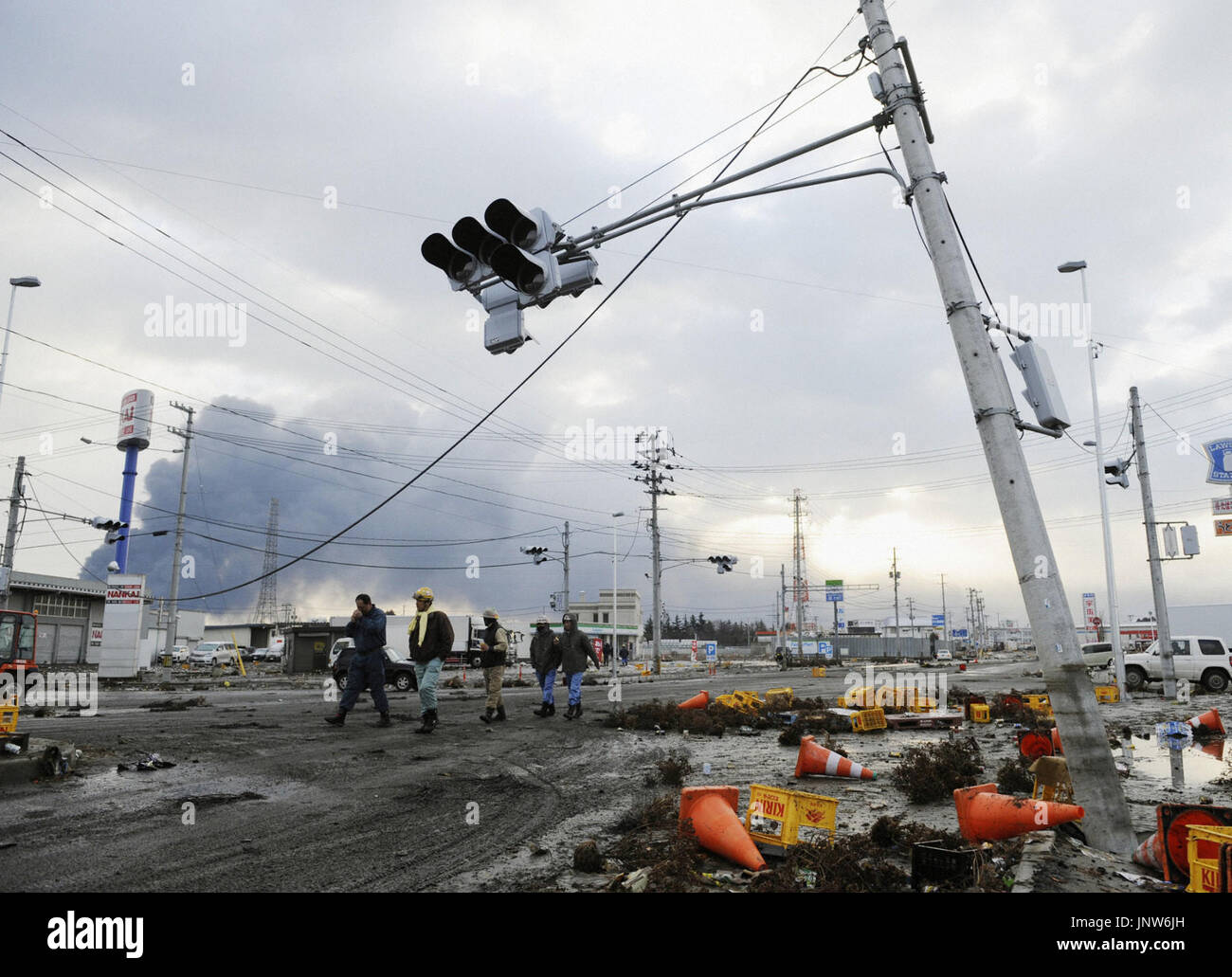 SENDAI, Japan - People walk near a damaged stoplight in Sendai, Miyagi ...