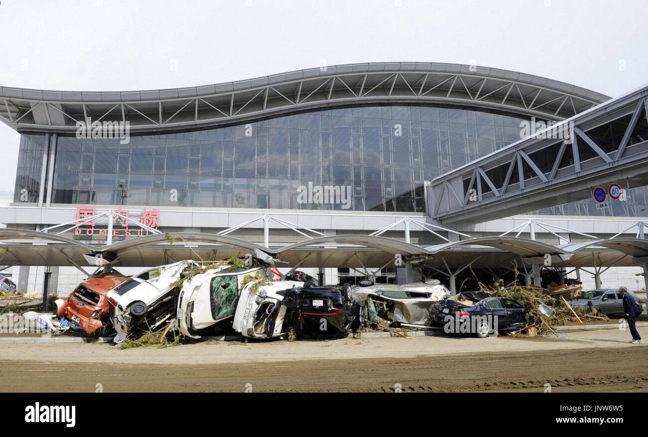SENDAI, Japan - Piles of cars wrecked by tsunami are seen at Sendai ...