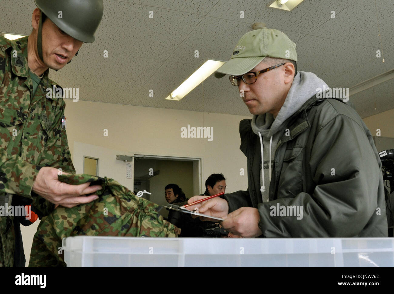 MORIOKA, Japan - A reservist (R) receives a uniform after arriving at ...