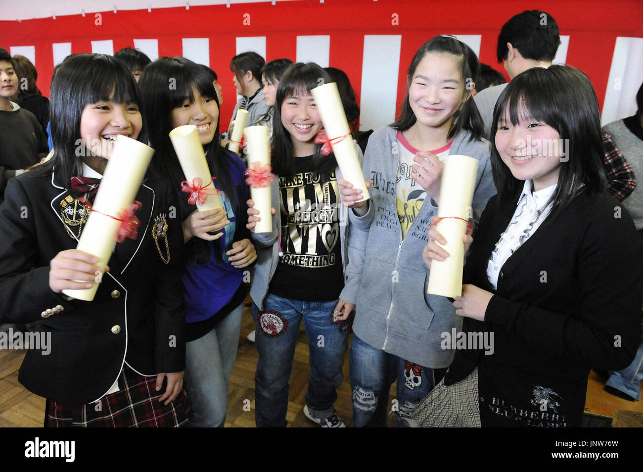 ONAGAWA, Japan - Sixth graders smile and hold their certificates of ...