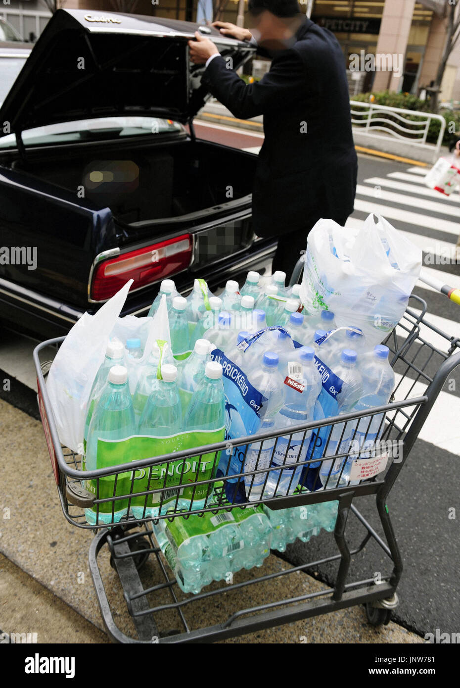 TOKYO, Japan - A customer buys a lot of bottled water in Tokyo on March ...