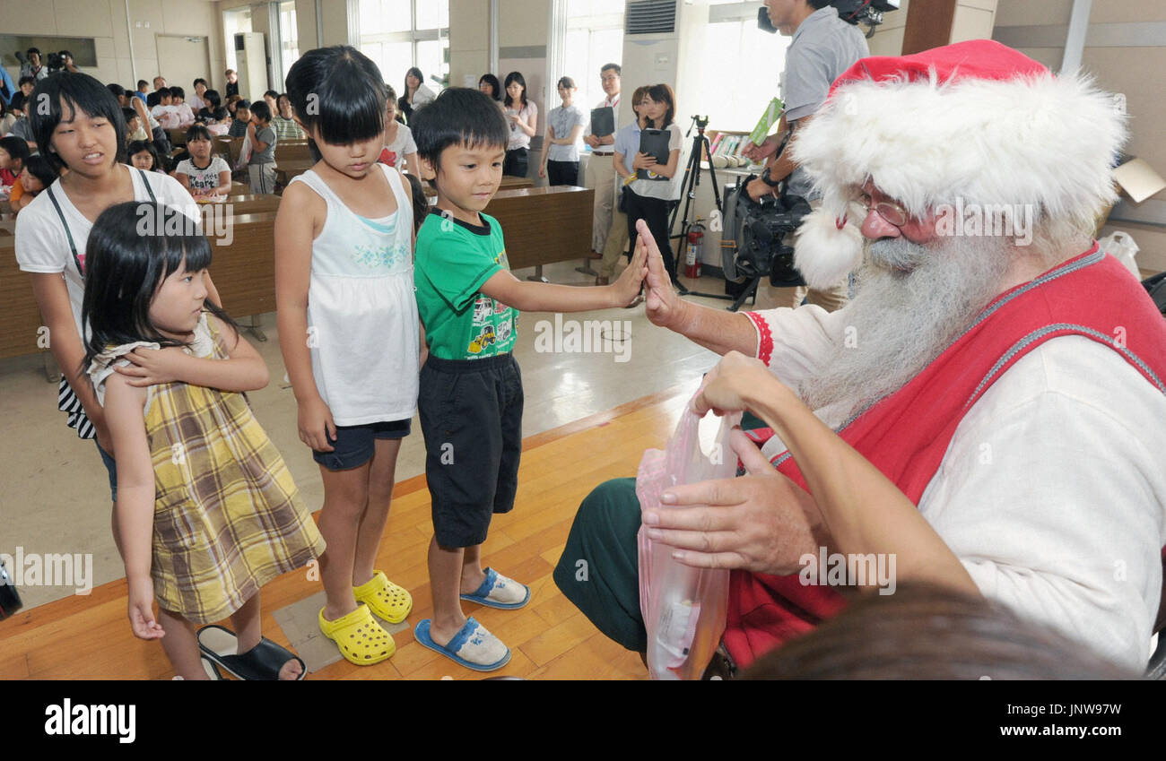 KAZO, Japan - Santa Claus from Finland in summer attire gives presents ...