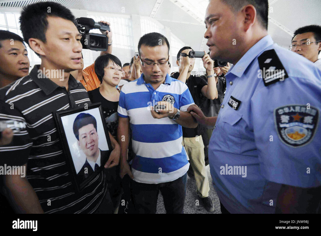 WENZHOU, China - A relative (L) of one of the victims of a fatal bullet ...