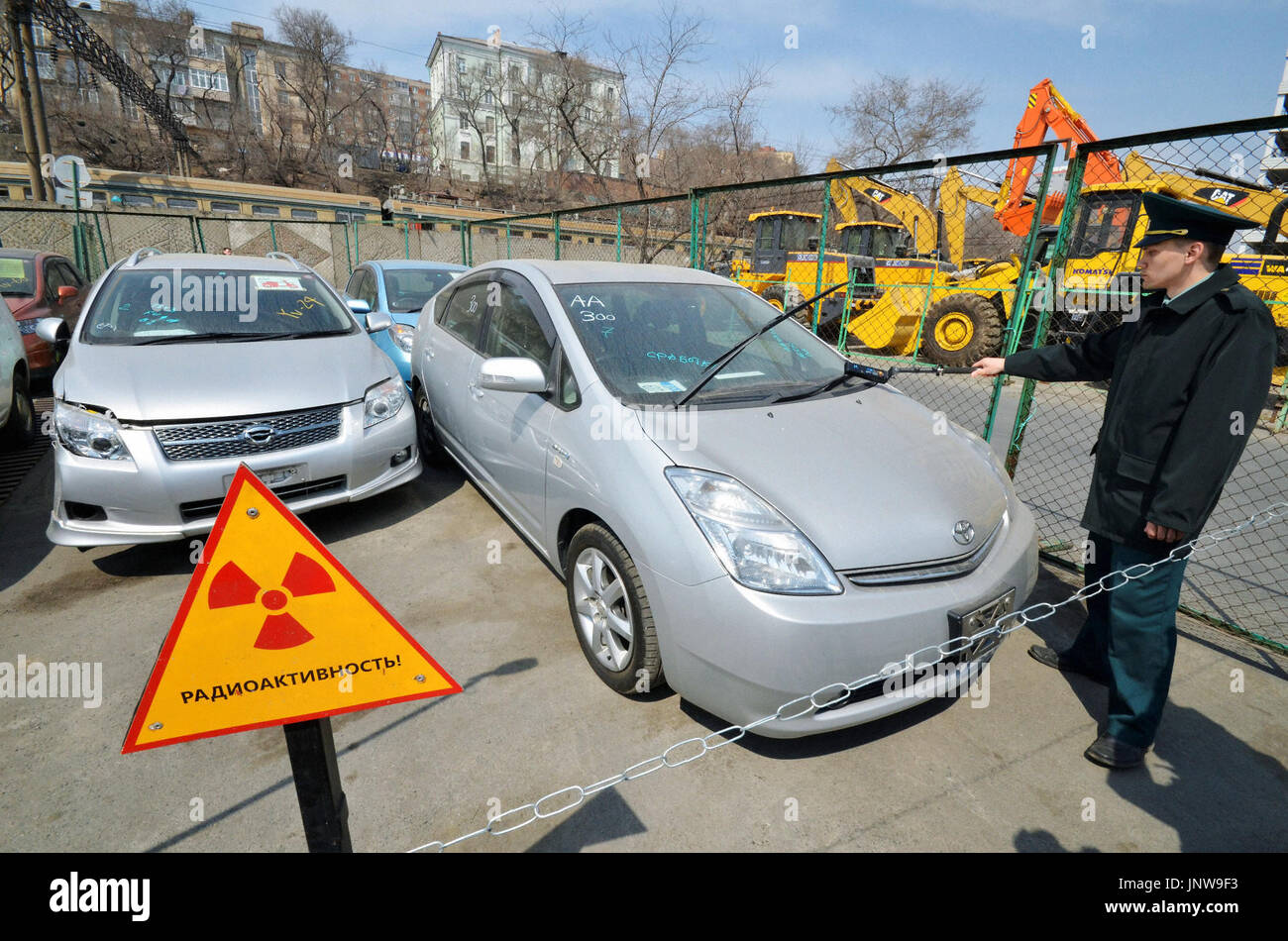 VLADIVOSTOK, Russia - An official examines radiation levels of cars ...
