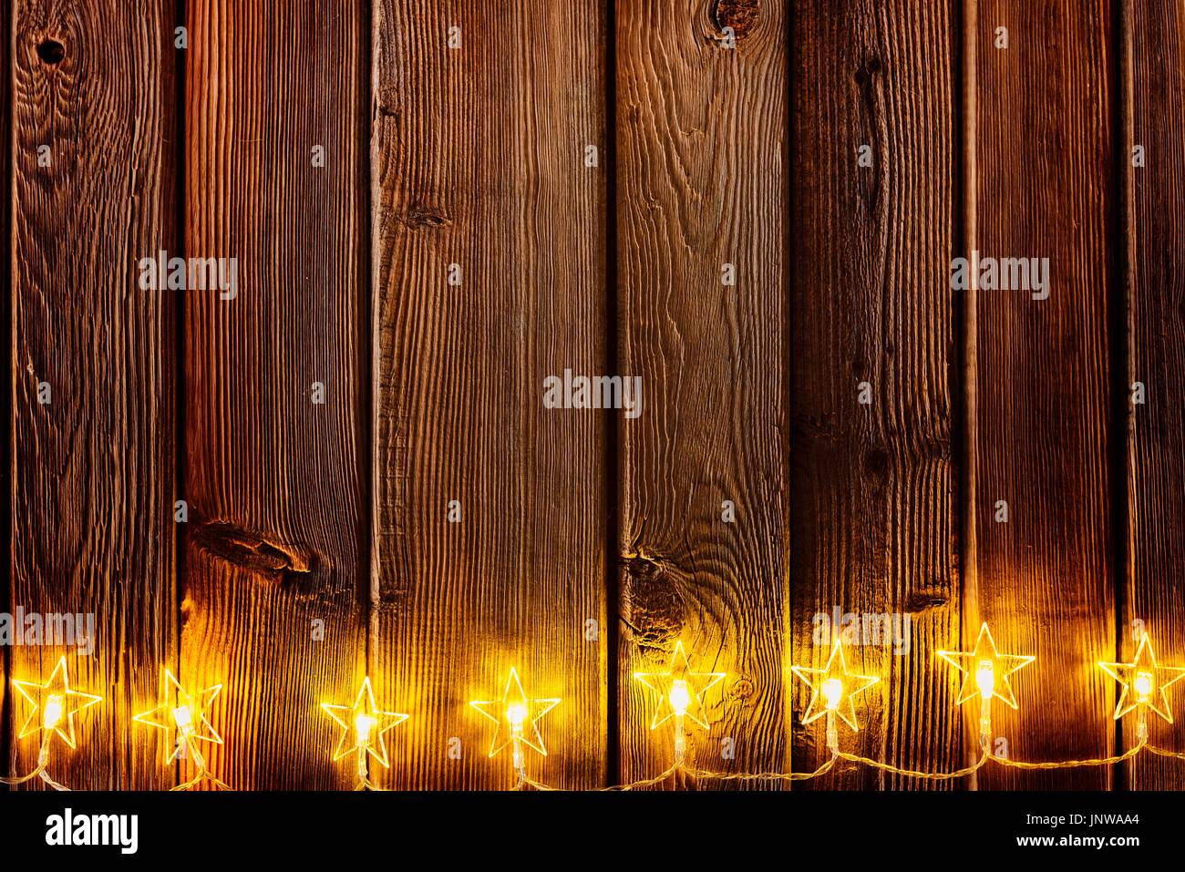 Christmas lights on wooden rustic background. Frame of lights with ...