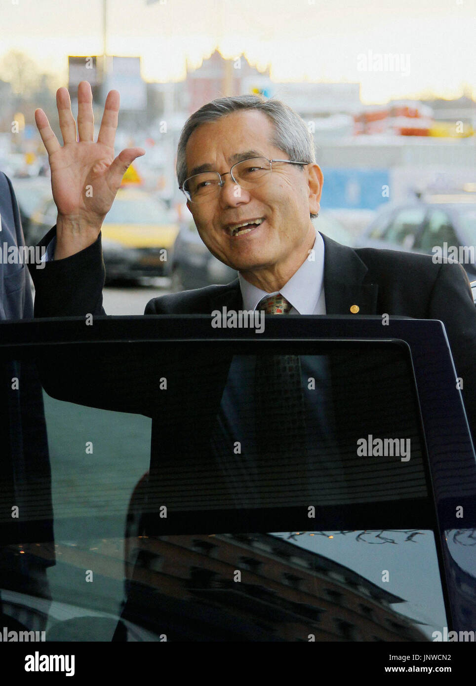 STOCKHOLM, Sweden - Japanese chemist Eiichi Negishi waves upon leaving ...