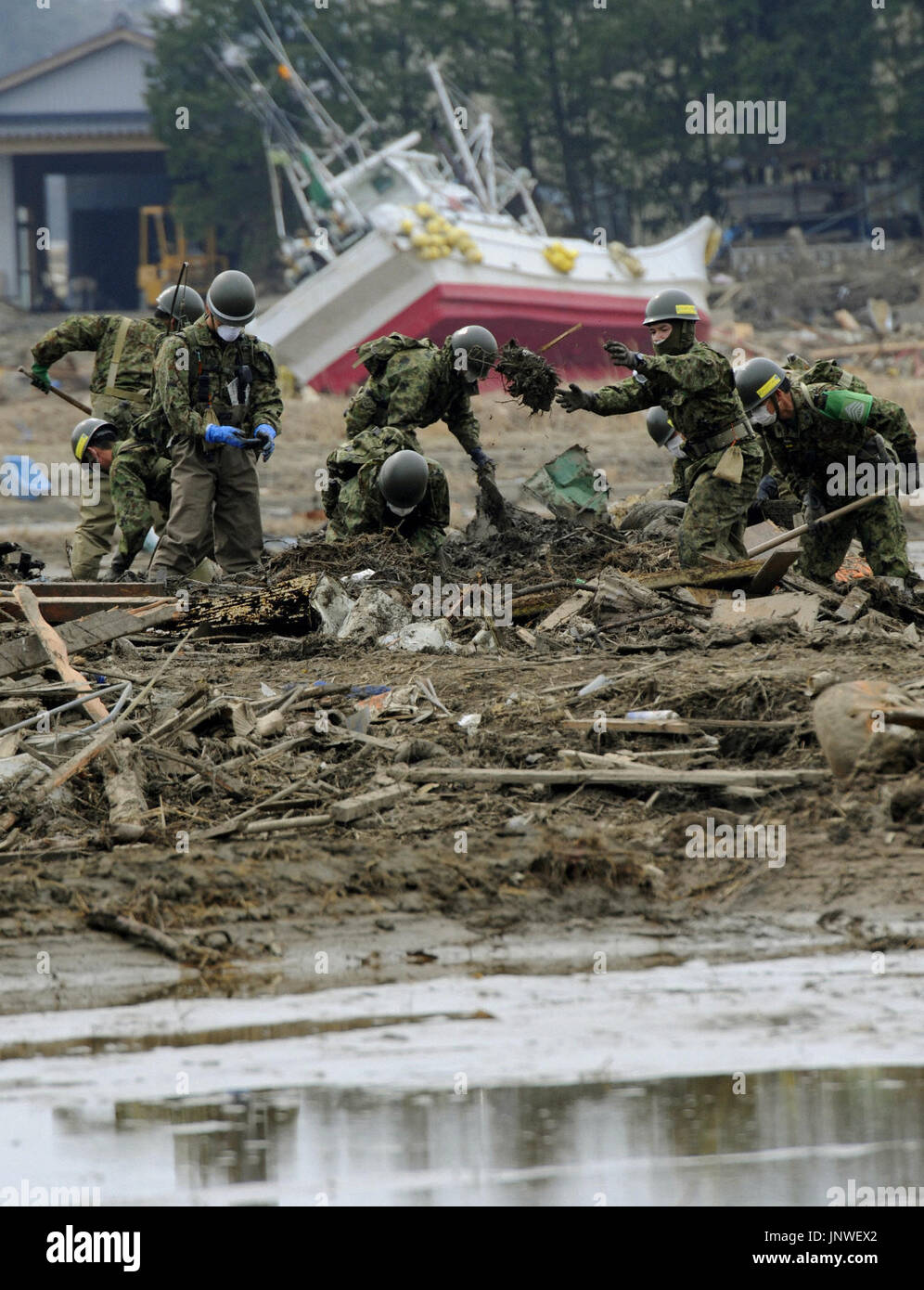 SOMA, Japan - Members of the Japan Self-Defense Forces search through ...