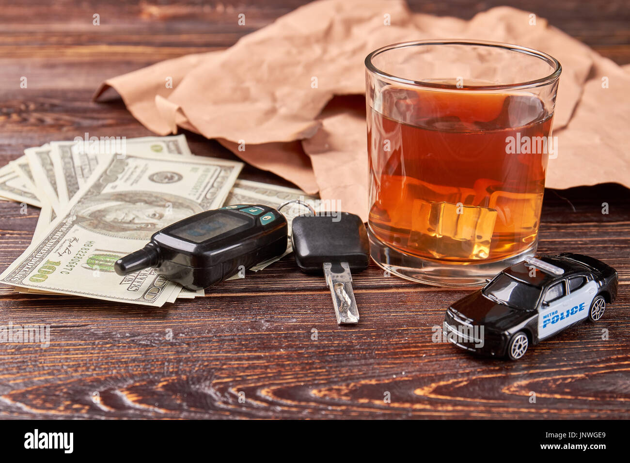 Dollars, keys, whiskey, police car Stock Photo - Alamy